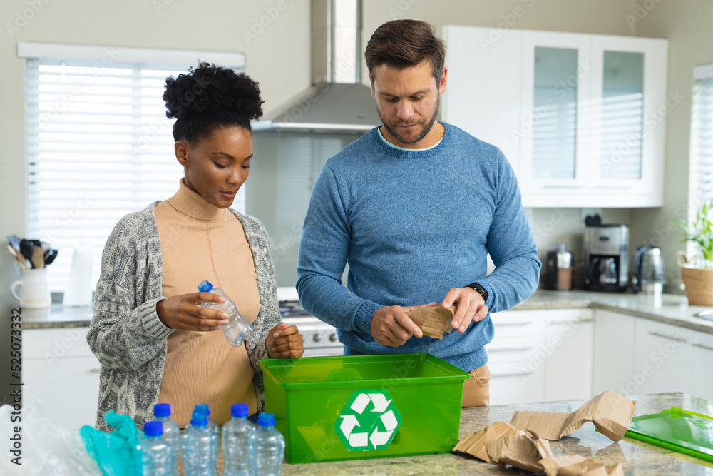 Image of happy diverse couple recycling plastic bottles Stock Photo ...