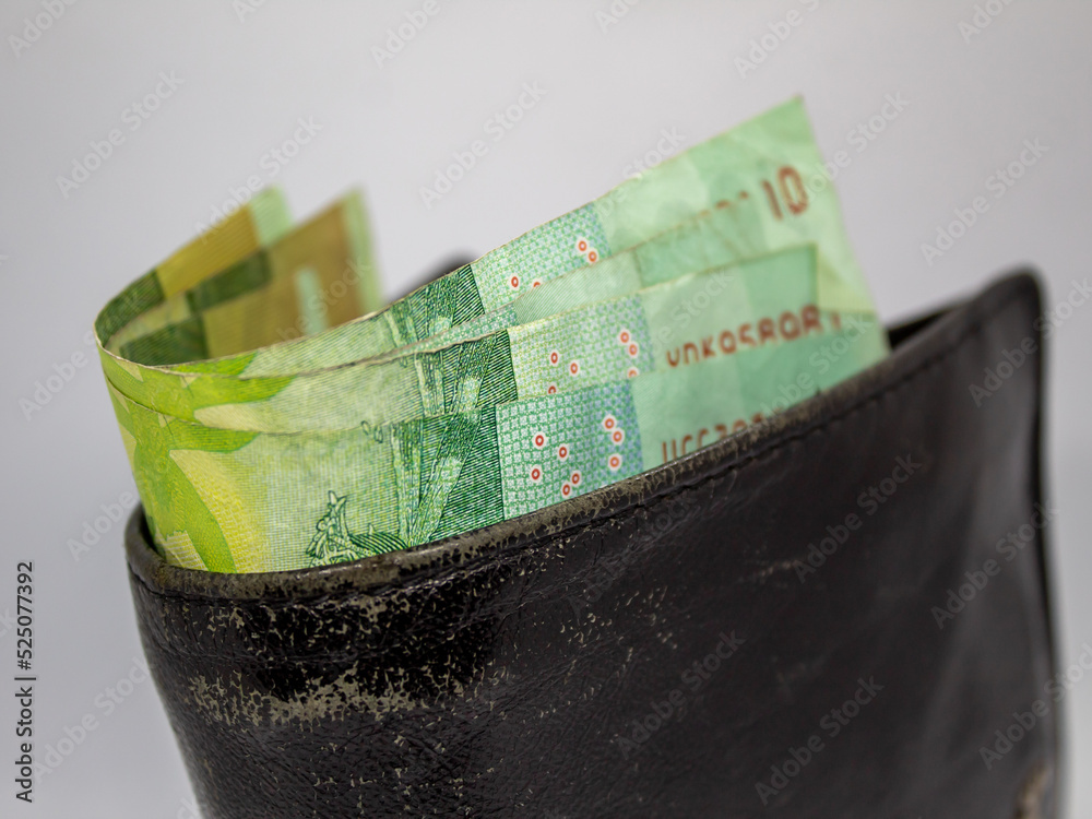 selective focus black wallet containing Indonesian money, Rupiah ...