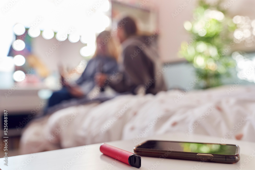 Group Of Teenage Girls In Bedroom With Vape Pen And Mobile Phone In ...
