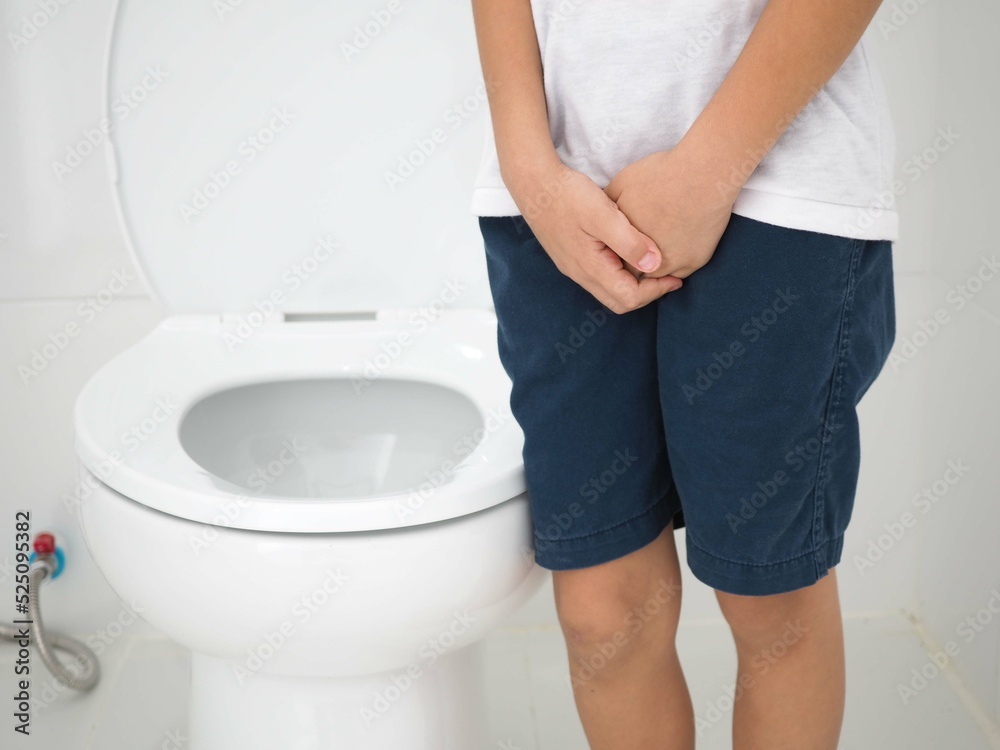 Child stood in the bathroom. With severe ache pee. Closeup photo ...