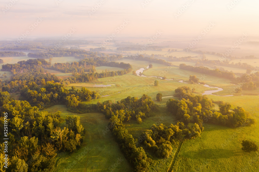 Nature scenery with floodplains and riparian forests illuminated by ...