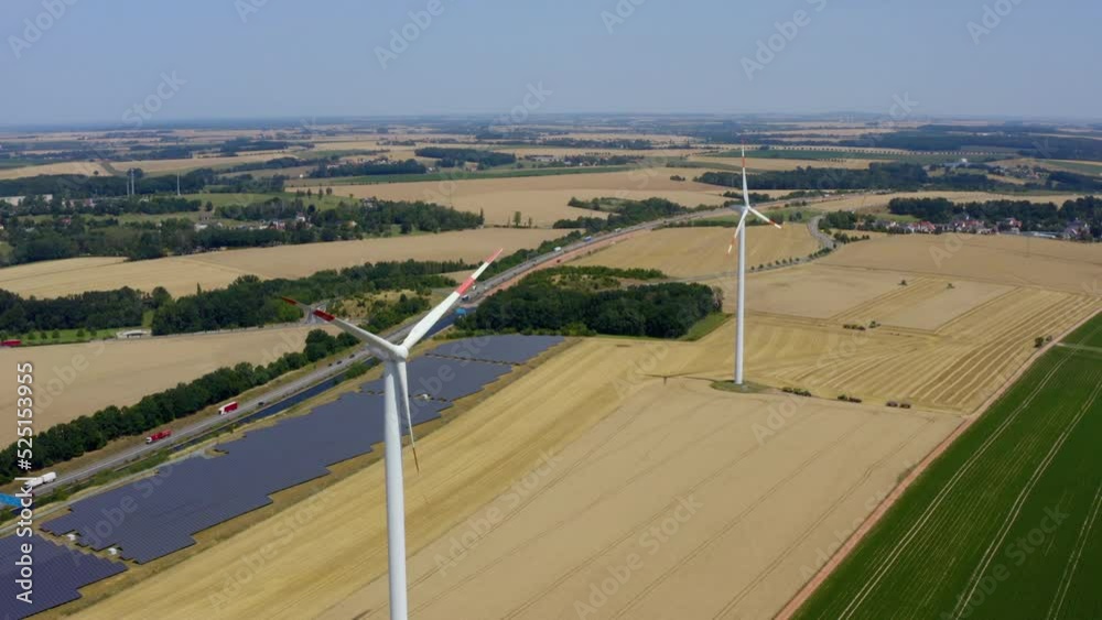 Solar panel cells and rotating wind turbines on the green energy farm ...
