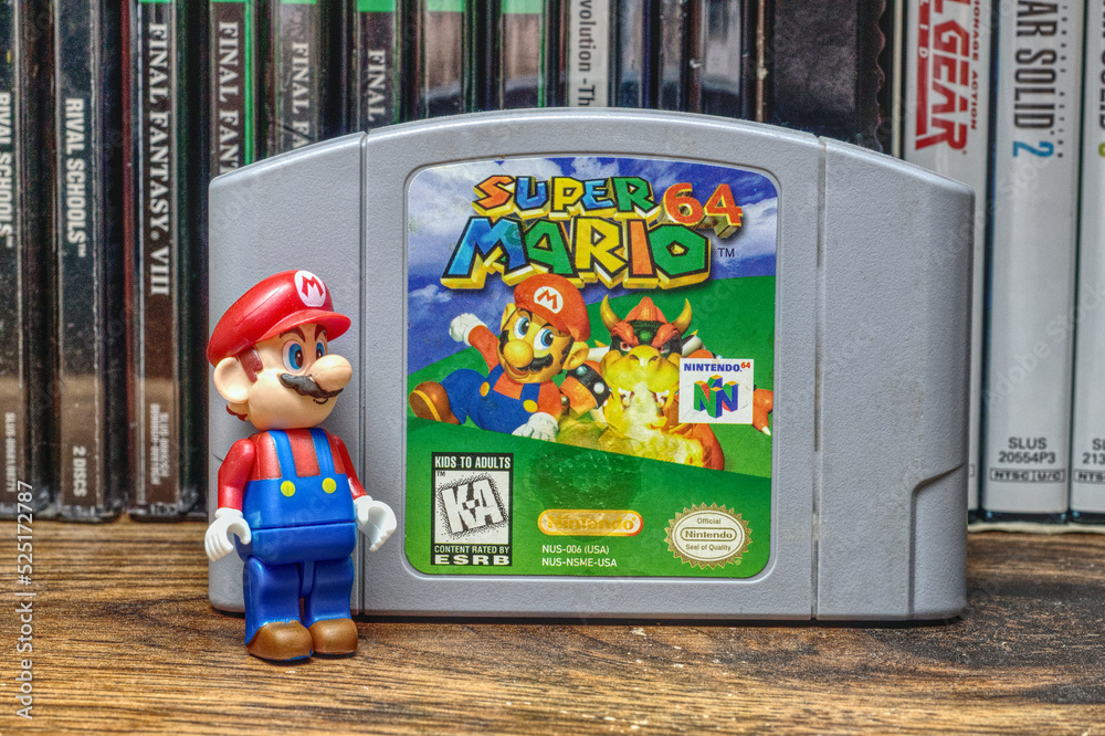 Mario toy beside Super Mario 64 Cartridge (NC State, 2022) Stock Photo ...
