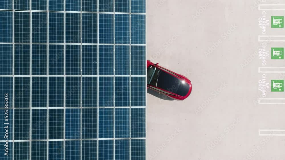 Top down aerial Alternative energy ecological red car at EV charging ...