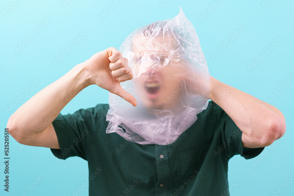 A man suffocating because of a plastic bag on his head shows his thumb ...