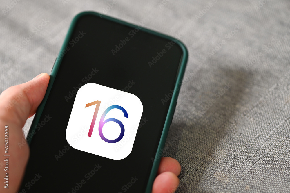 iPhone with iOS 16 logo on the screen close up, new operating system ...