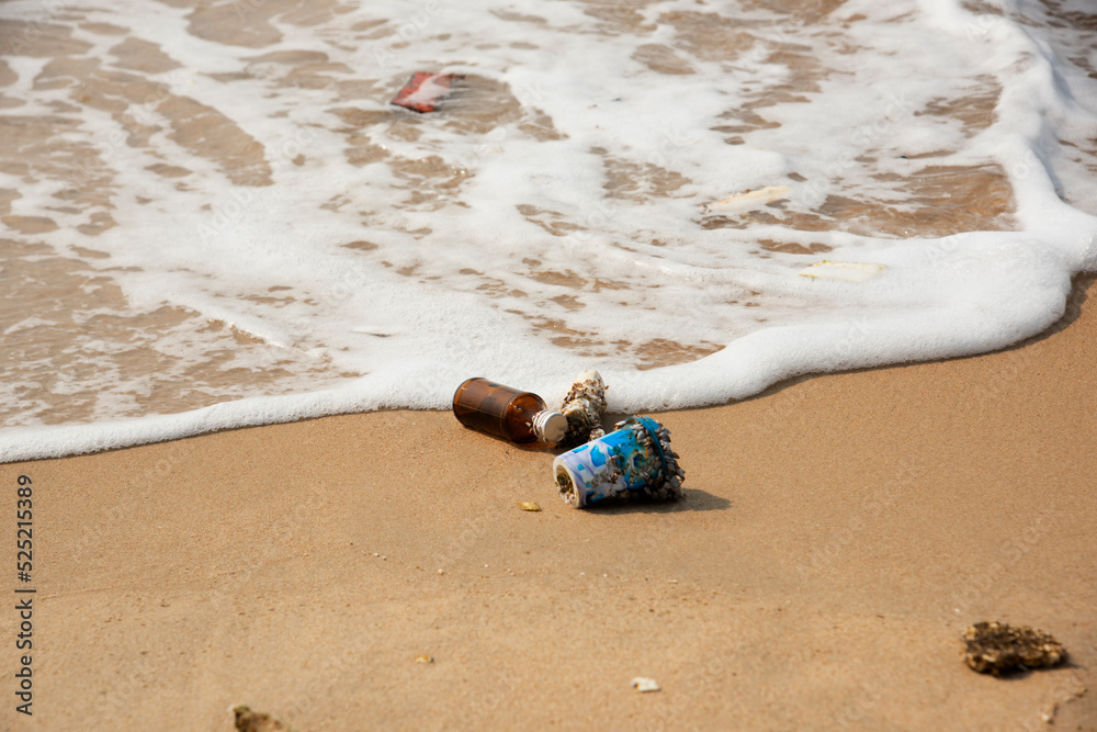 garbage on the baech Beach pollution. Plastic bottles and other trash ...
