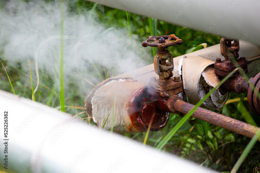 Rust destroys paint and red pipe flanges are leaking. Corrosion steam ...
