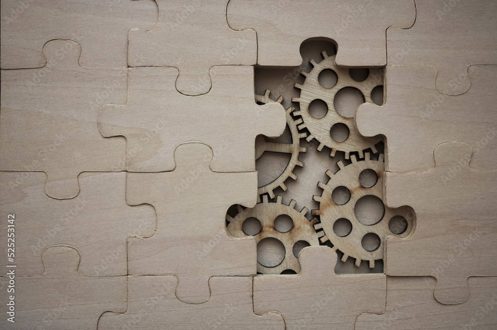 solving the problem concept - puzzles and cogwheels. wooden gears under ...