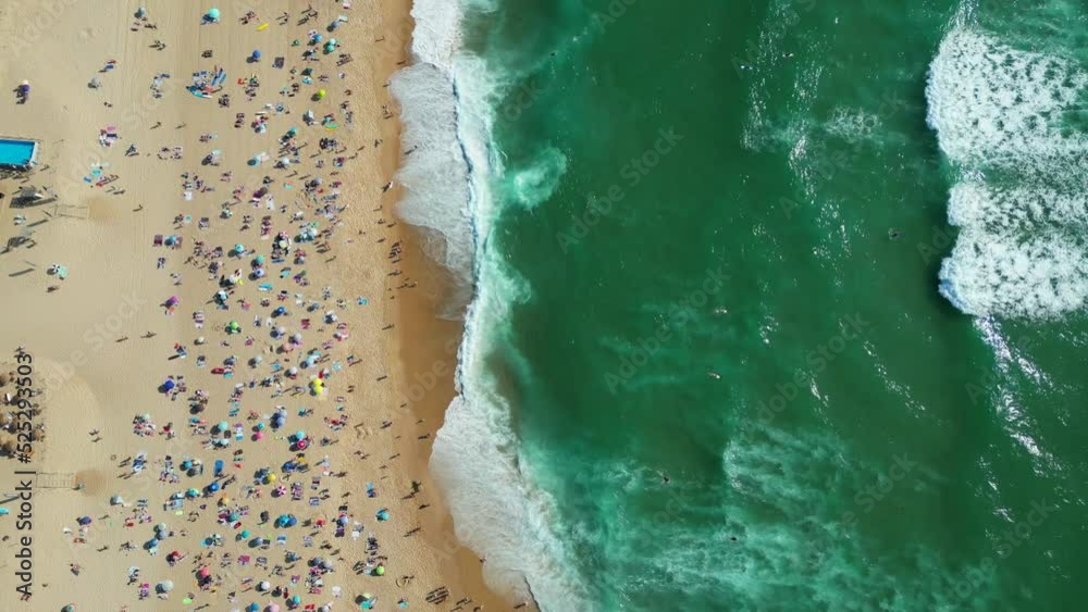 Top down aerial view of a beach in summer with holidaymakers on the ...
