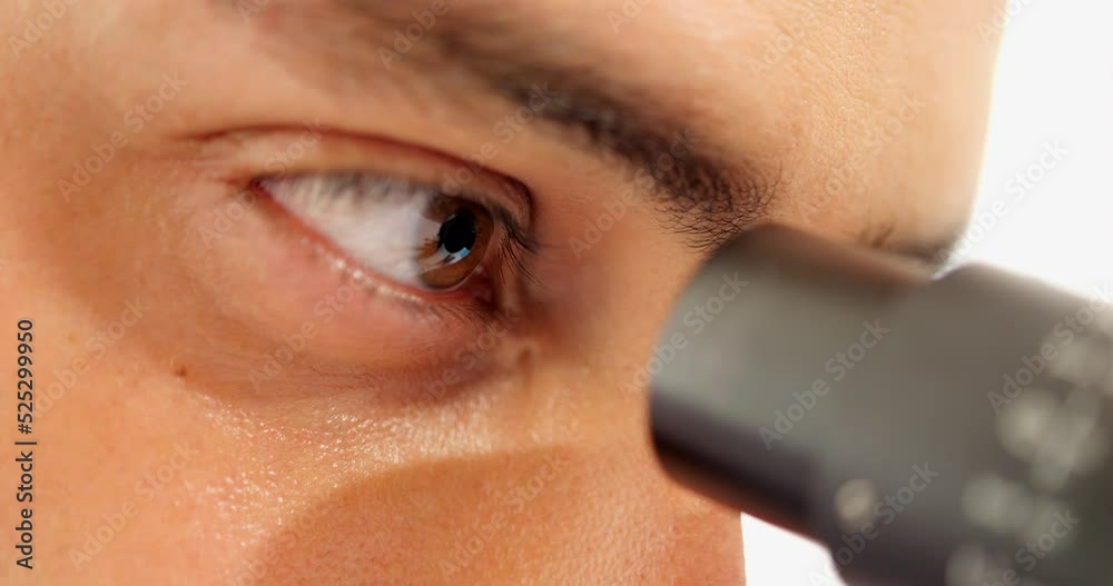 Close up eye of professional male scientist looking through microscope ... Close up eye of professional male scientist looking through microscope ...