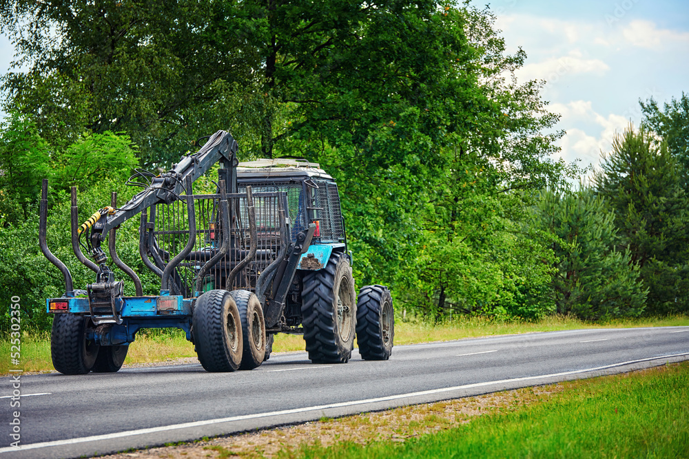 Tractor with trailer for logging. Log carrier machine. Tree harvester ...