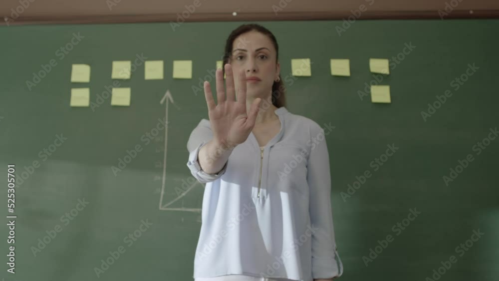 Unhappy teacher posing with hand, refusing ban. The female teacher does ...