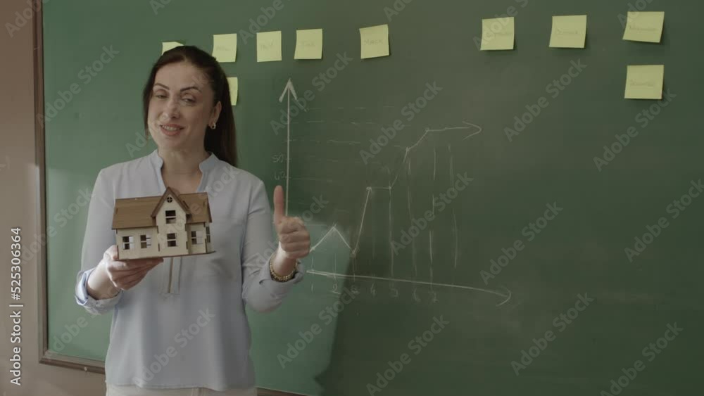 Video Stock Female realtor explaining model house to sales team or ...