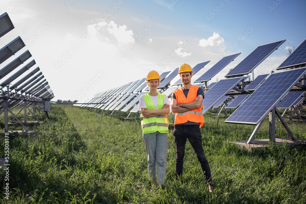 At large photovoltaic solar farm two ecological engineers young looking ...