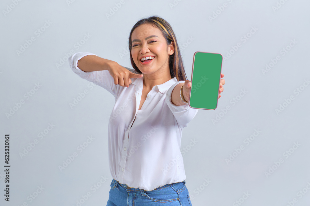 Excited young Asian woman showing blank screen mobile phone ...
