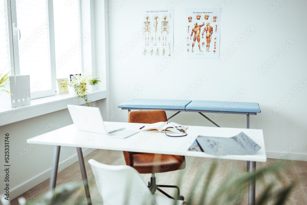 Interior of empty pediatrician office with bed and computer. Doctor's ...