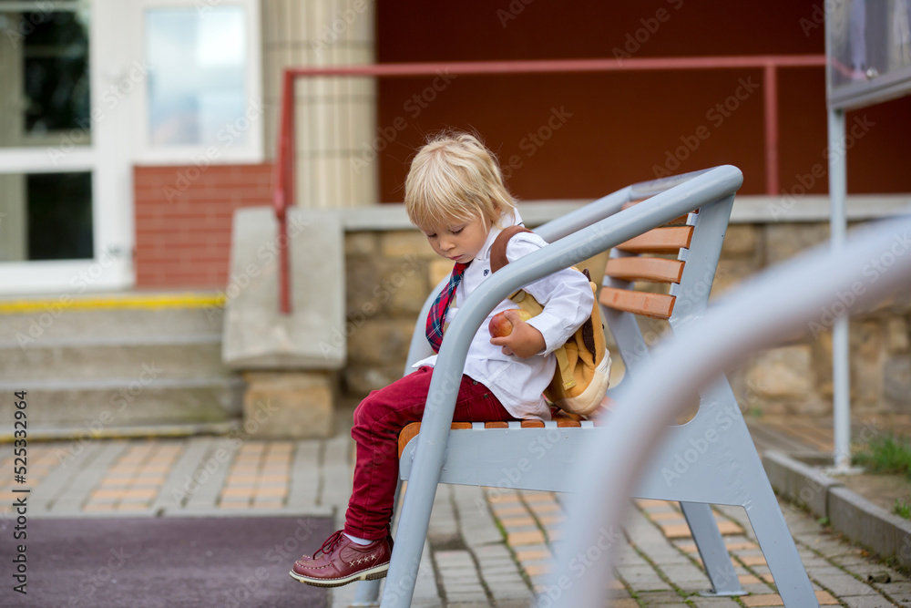 Preschool blond child, cute boy in uniform, hodling apple and book ...