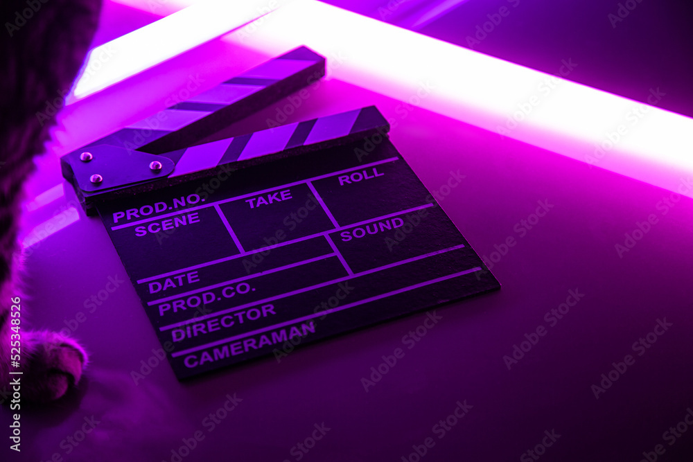 Clapperboard movie slate on Glowing neon lighting background. video ...