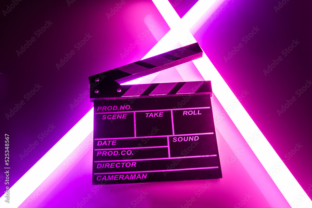 Clapperboard movie slate on Glowing neon lighting background. video ...