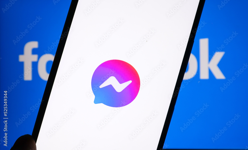 Facebook messenger logo on phone screen and Facebook logo background on ...
