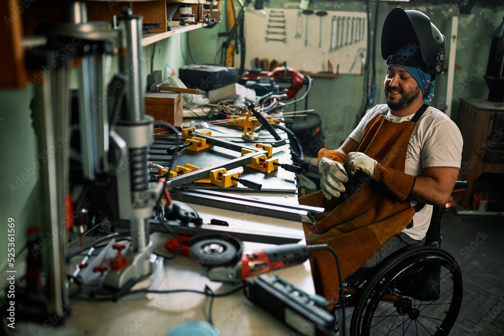 Side view on craftsman in a wheelchair wearing a welding helmet. Stock ...