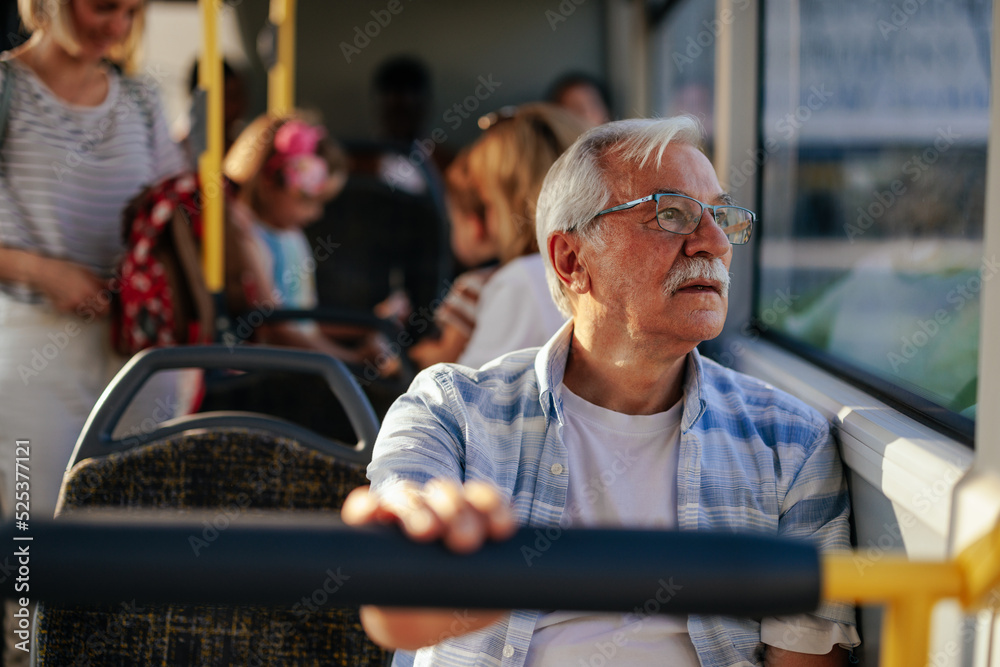 Elderly man in public transport Stock Photo | Adobe Stock