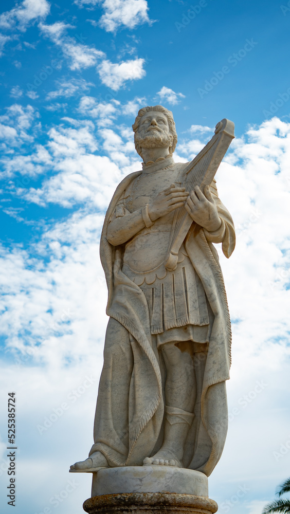 Marble statue of male figure wearing a crown and holding a harp at the ...