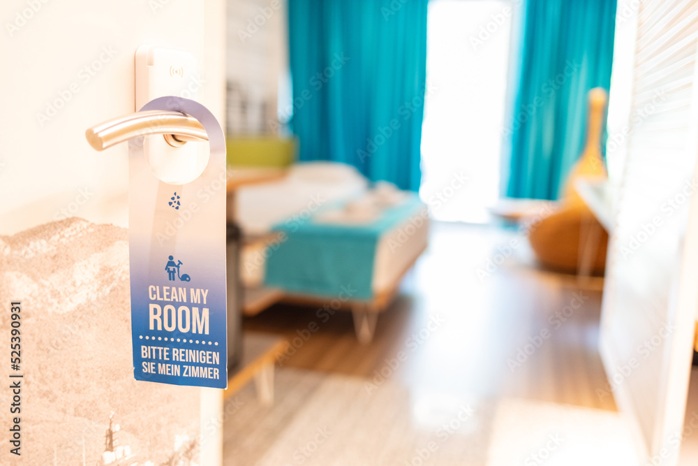 Hotel room with label on a door handle. Door of hotel room with ''clean ...