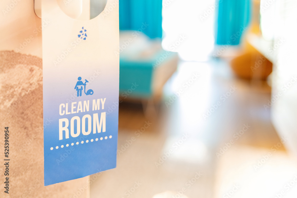 Hotel room with label on a door handle. Door of hotel room with ''clean ...