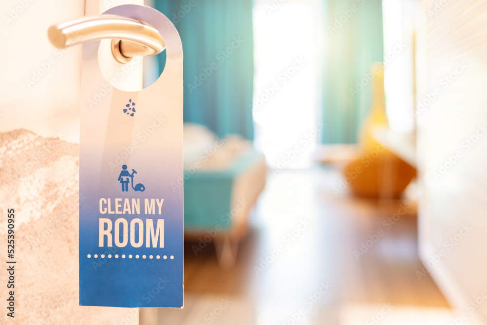 Hotel room with label on a door handle. Door of hotel room with ''clean ...