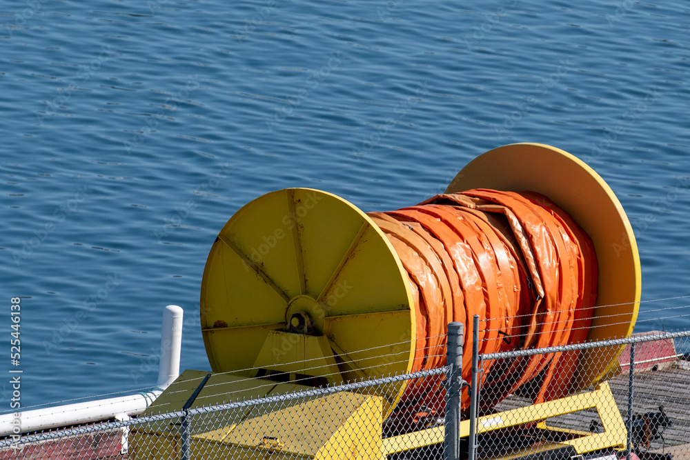 An industrial reel of orange oil sorbents spills containment boom ...