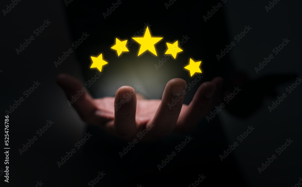 Hand of customer or client holding the stars to complete five stars ...