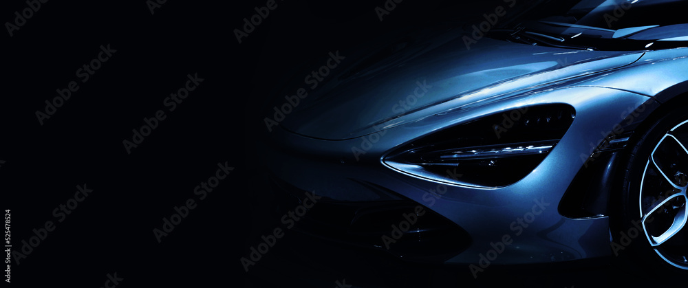Detail on one of the LED headlights super car in blue tone on black ...