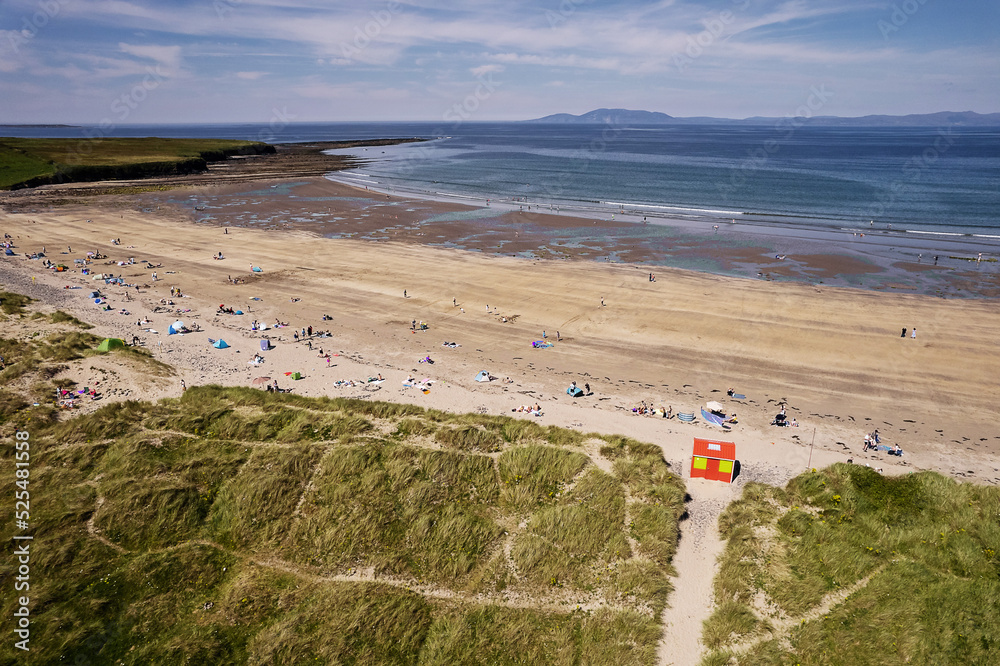 People sunbathing on Streedagh beach in county Sligo, Ireland ...