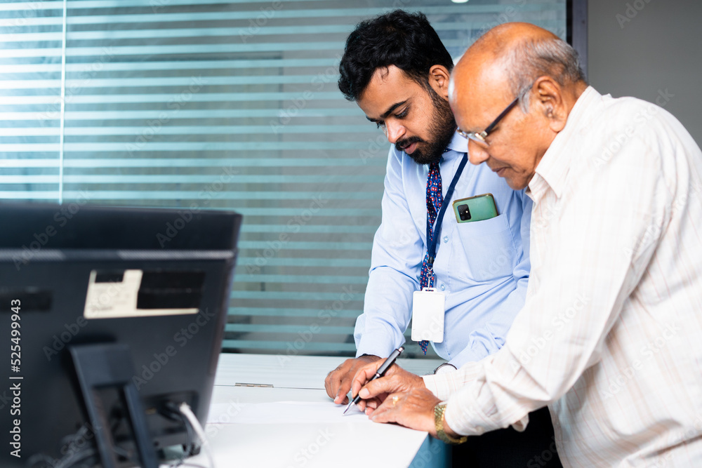 Focus on banker, Employee helping or guiding old man to fill receipt or ...