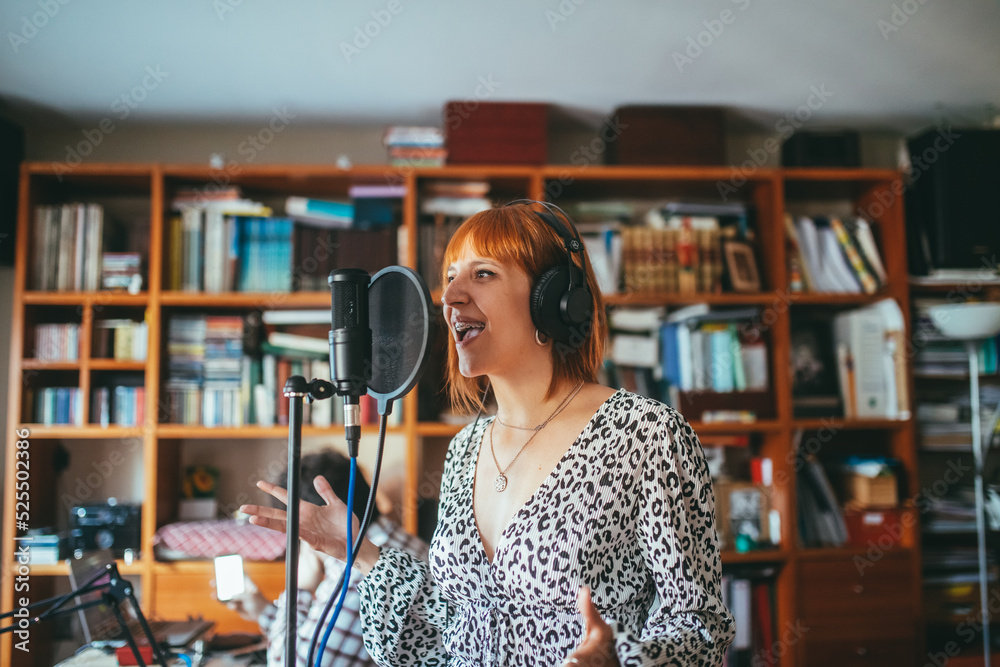 Singer performing song into microphone at home Stock Photo | Adobe Stock