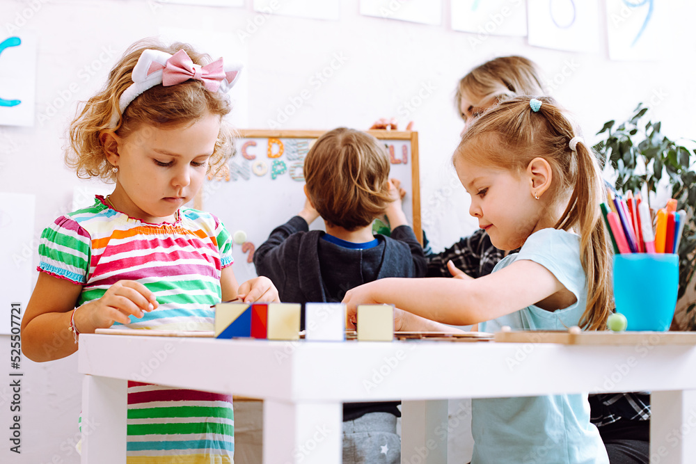 Group of wonderful children pupils studying with help of teacher woman ...