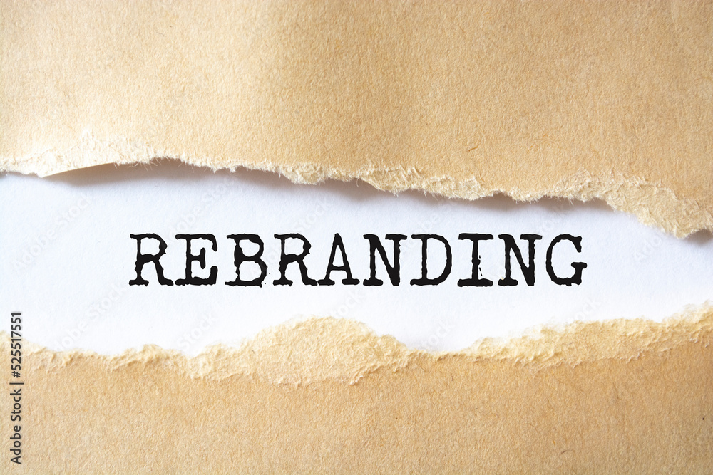 The text REBRANDING appearing behind torn brown paper Stock Photo ...