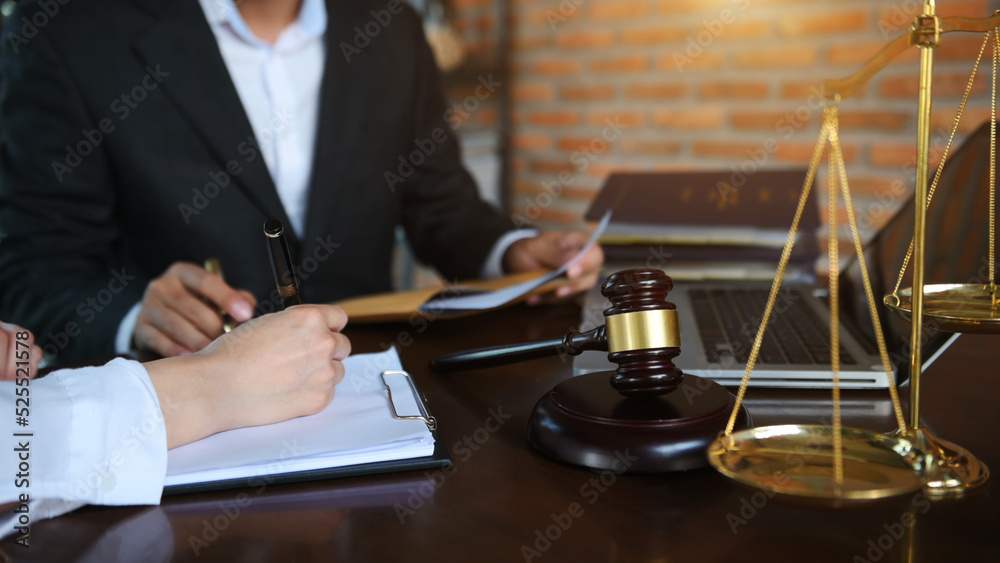 business people and lawyers discussing contract papers sitting at the ...