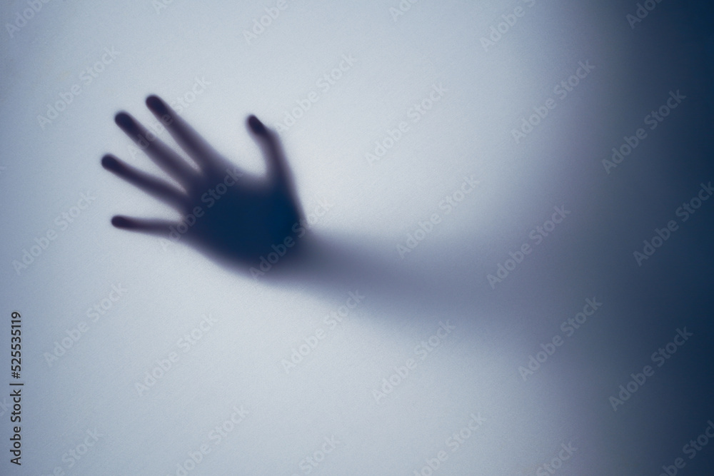 Shadow people. Right hand shadow blur behind frosted glass.The concept ...