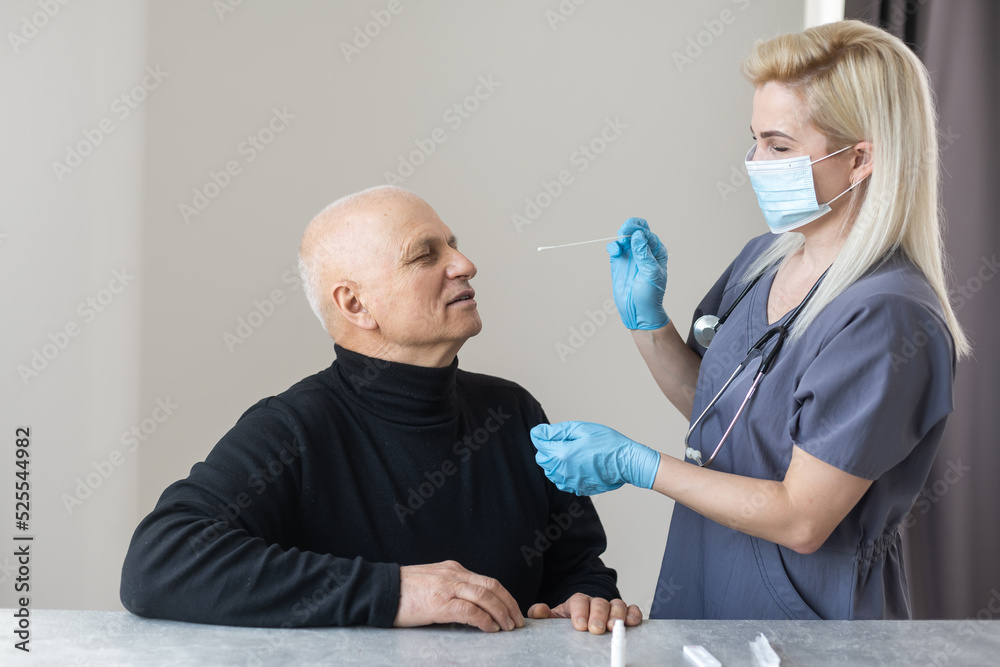 Close up of medical staff hands introducing the nasal swab to the ...
