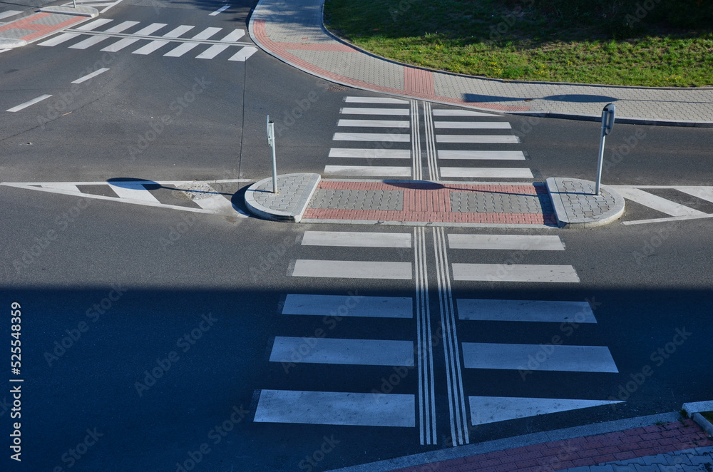 directionally divided lanes at intersection. crossing has a raised ...