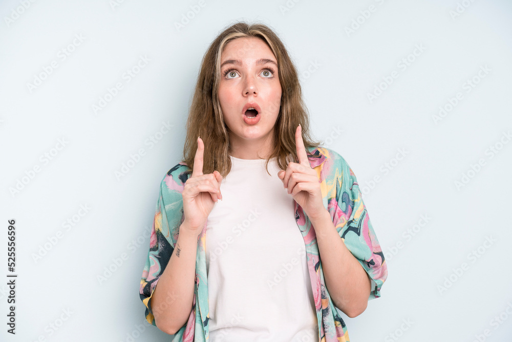 caucasian pretty woman feeling awed and open mouthed pointing upwards ...