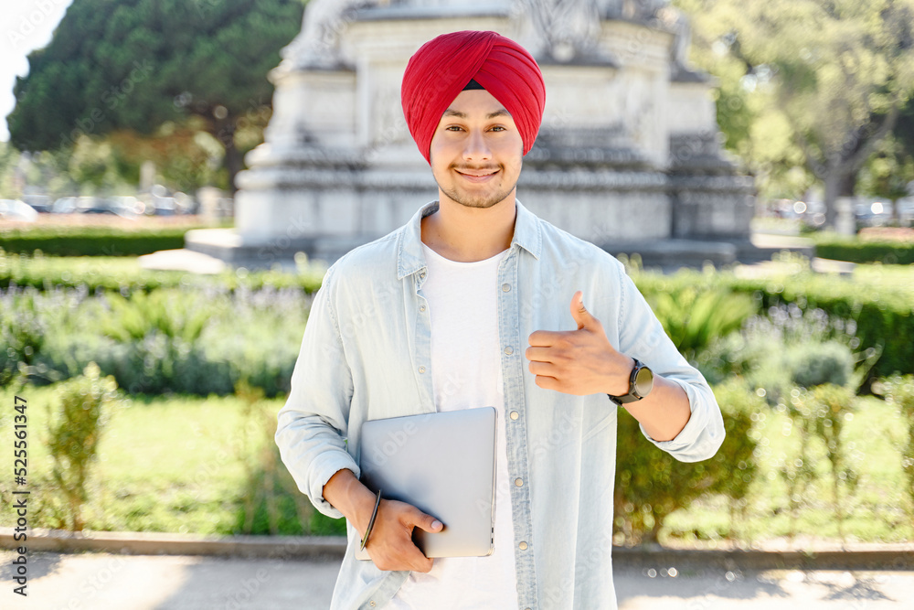 Positive smiling Indian man freelancer in turban showing thumbs up ...