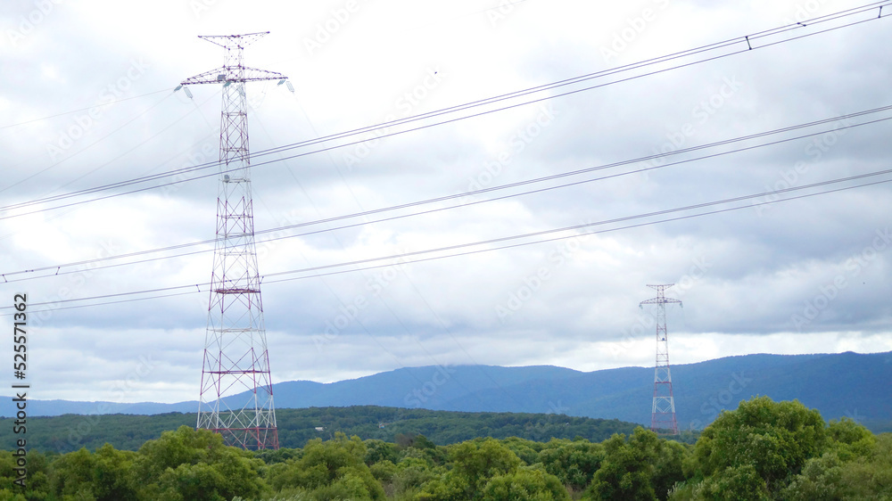 Fotka „Supports of high-voltage power lines. Filmed on the border of ...