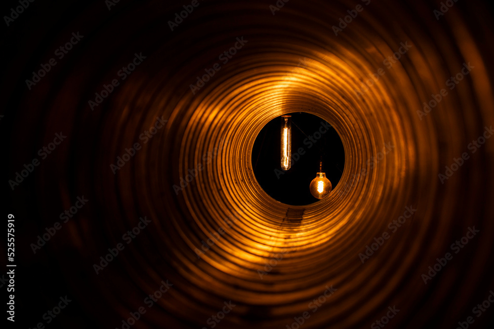 glowing bulbs with edison filament visible from the ventilation duct ...