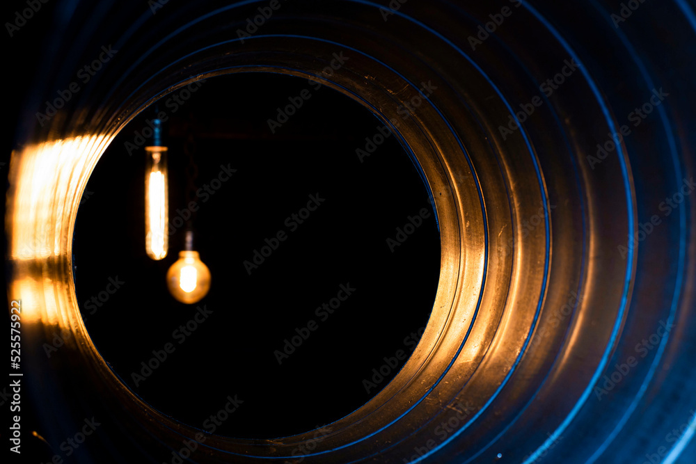 glowing bulbs with edison filament visible from the ventilation duct ...