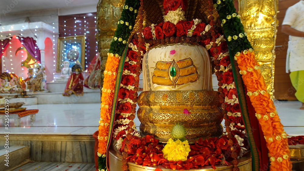 Tirupati, India 21st August 2022: Beautifully decorated Shivling. Devotees performing aarti and ...