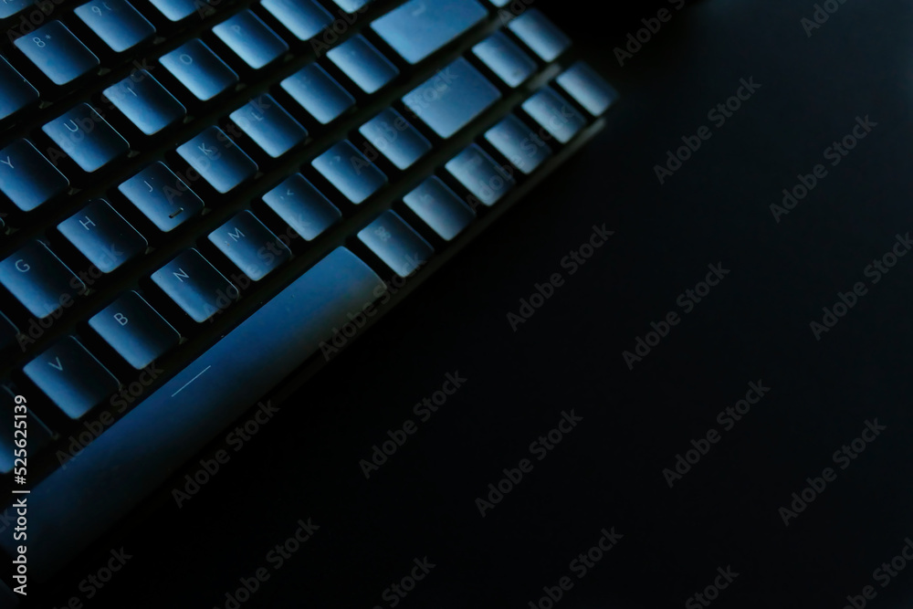 Black mechanical keyboard on a black desk Stock Photo | Adobe Stock